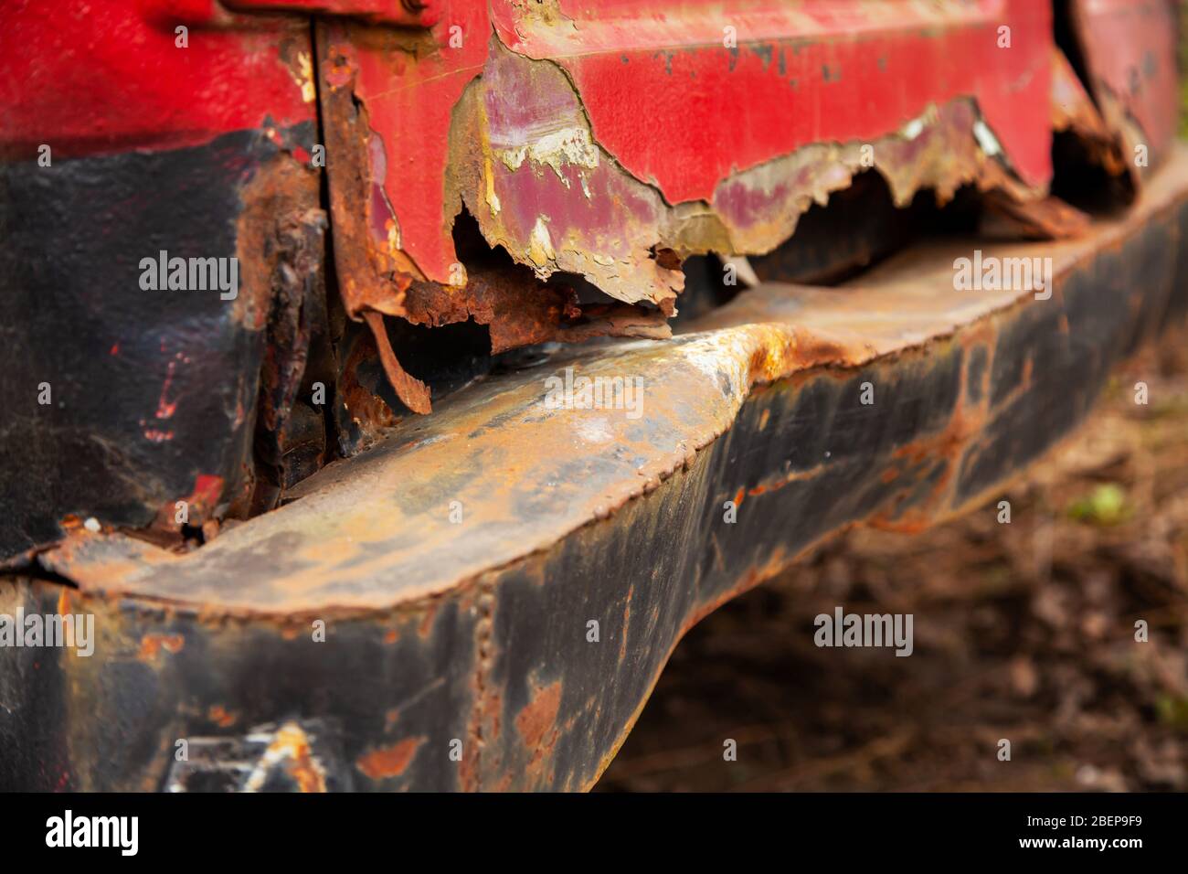 Rusty and bent back of the van. Old rusty bent rear bumper of a car ...