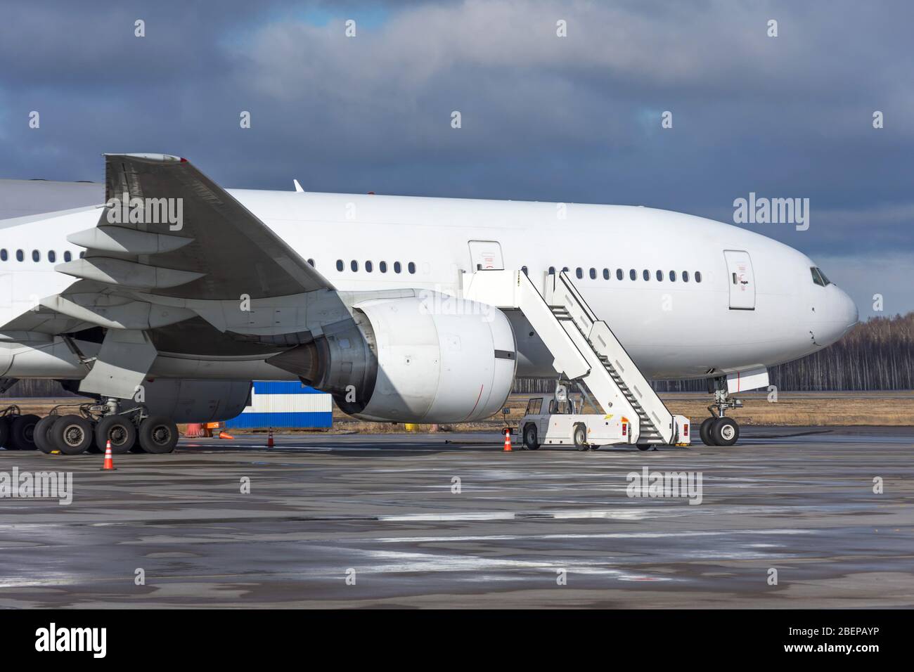 Large long-haul aircraft parked at the airport with stairs to the ...