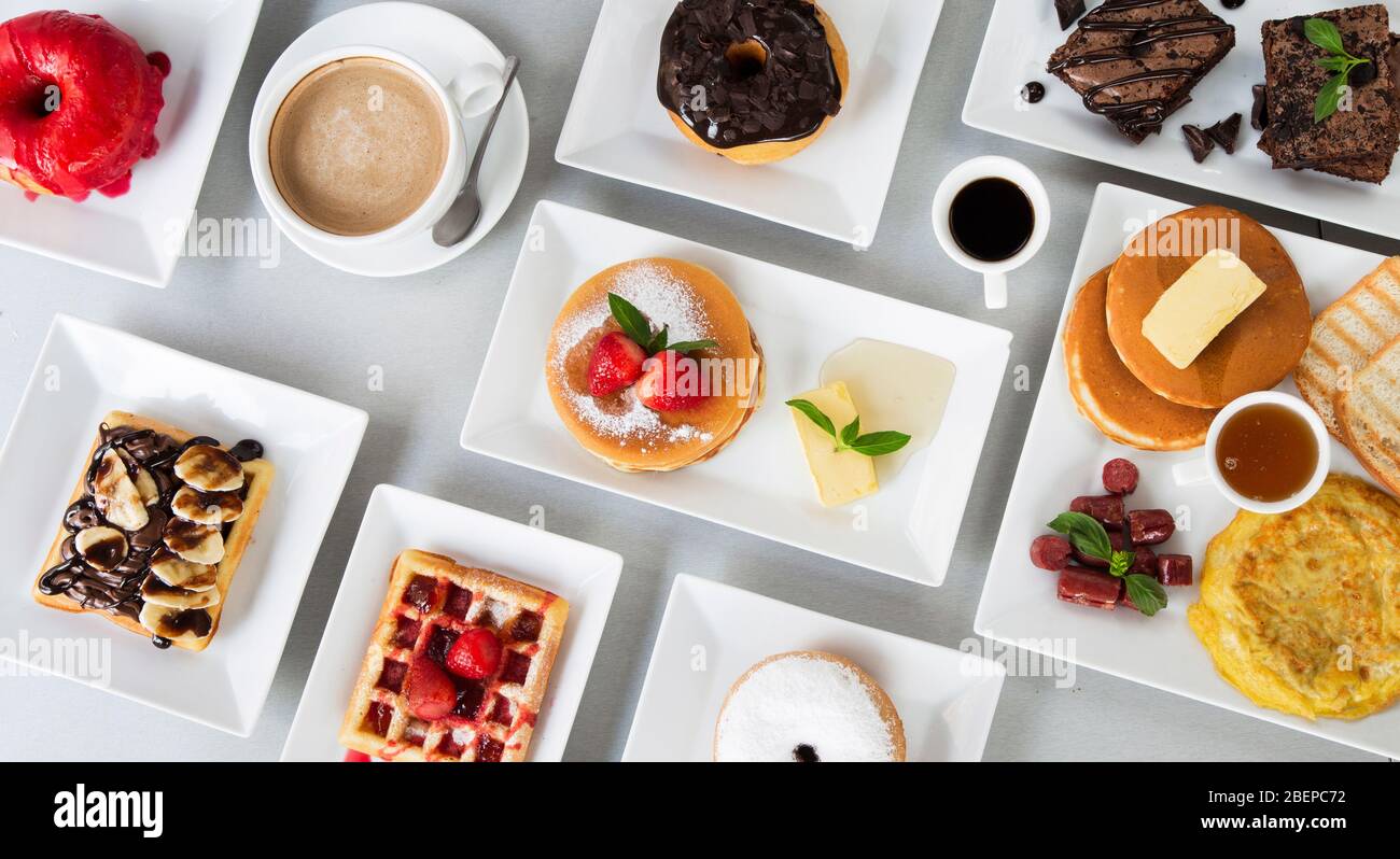 Breakfast variation with many kinds of meals. Top view of white table ...