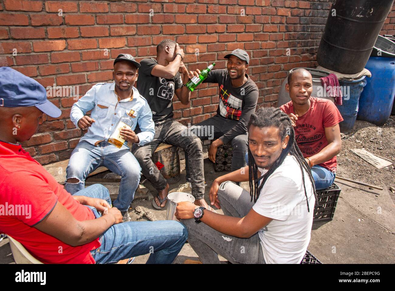 Young men drink with friends in a shebeen in a township in Cape Town ...