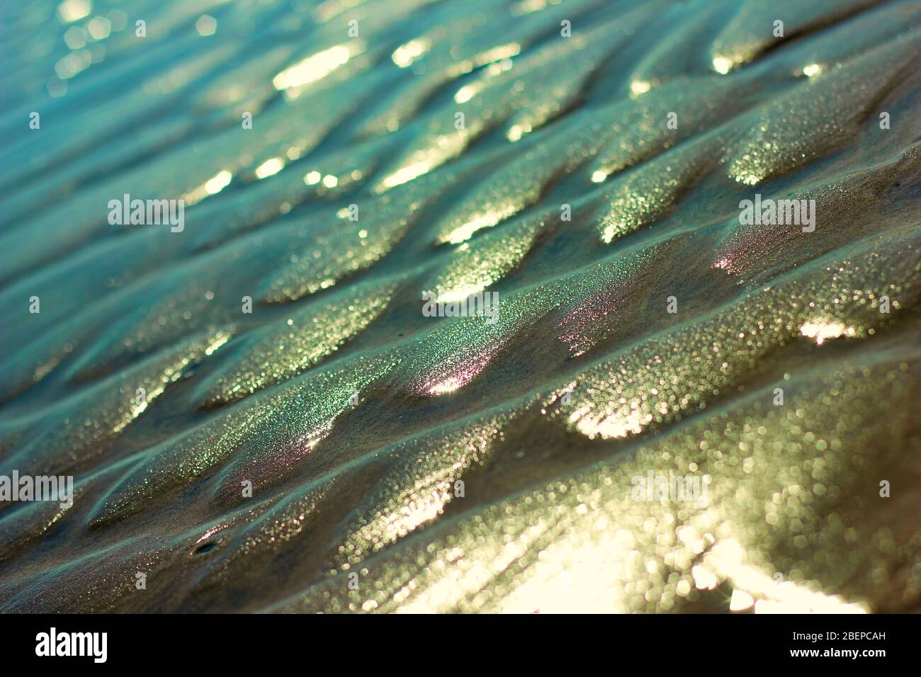Close-up view of sand with sun rays. Abstract sand shapes caused by sun ...