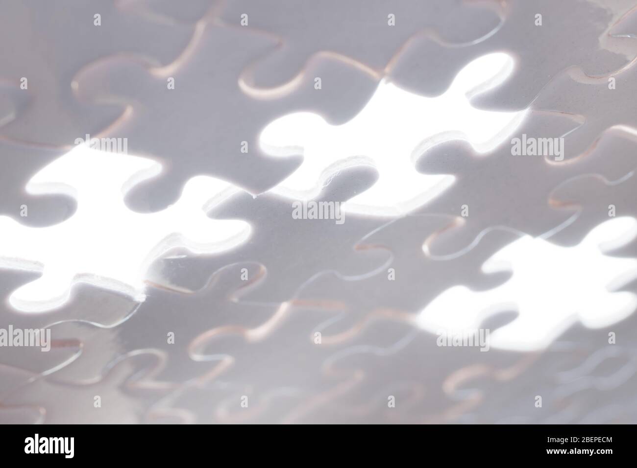 White jigsaw puzzle roof with glowing holes. Selective focus Stock ...