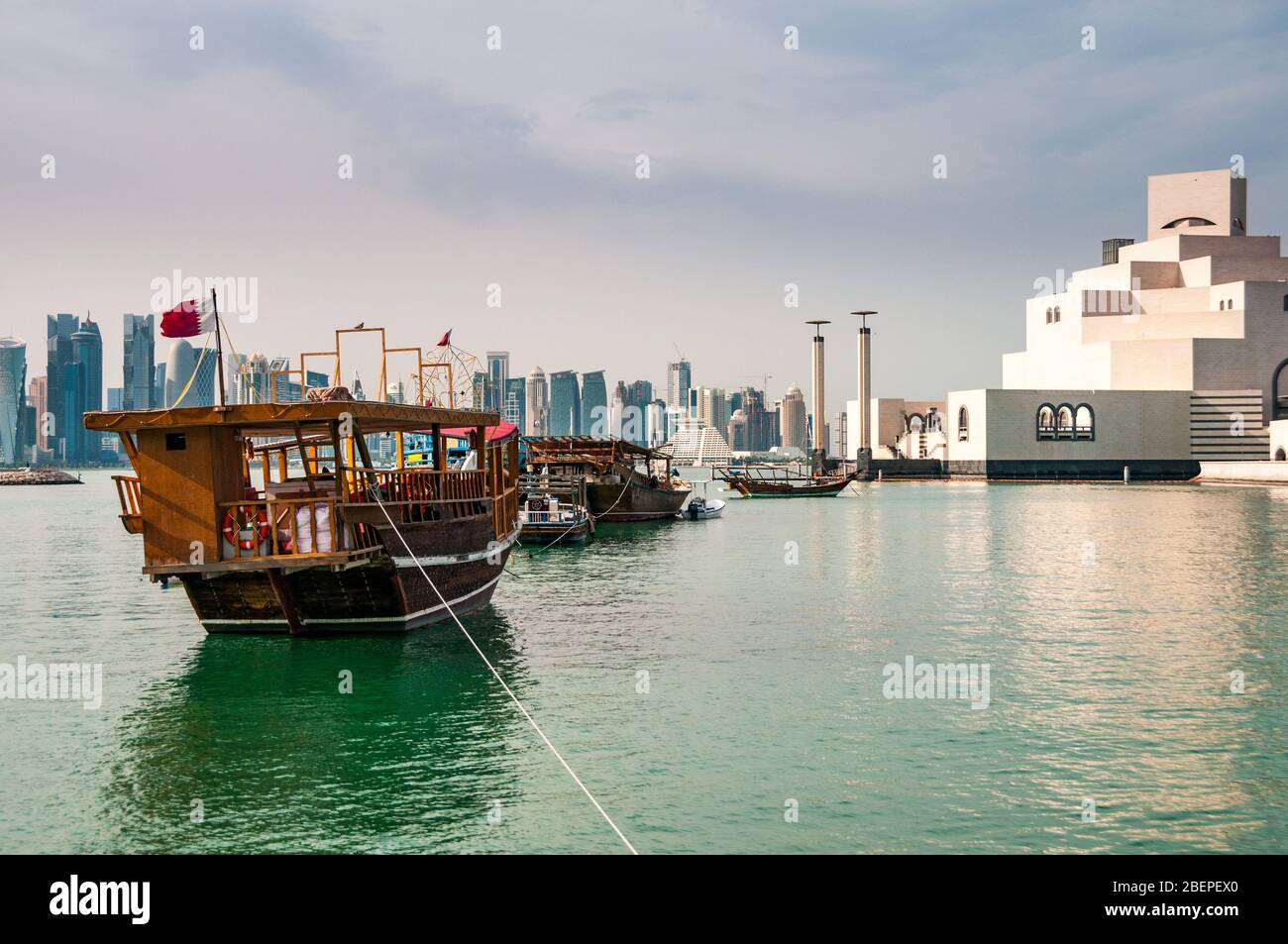 Dhow boats moored in front of the Museum of Islamic Art in Doha, Qatar ...
