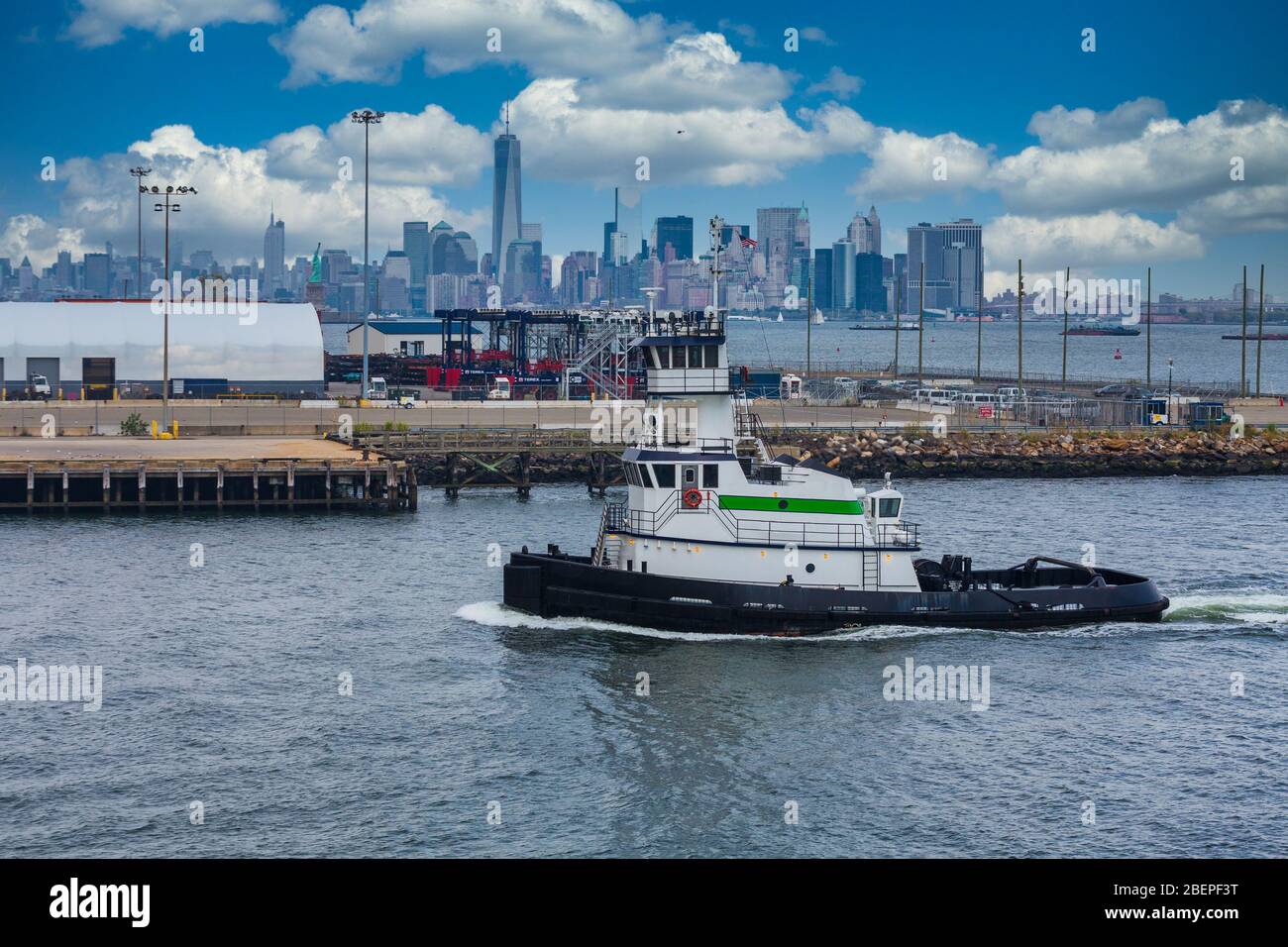 Green and White Tug Boat with New York in Background Stock Photo - Alamy