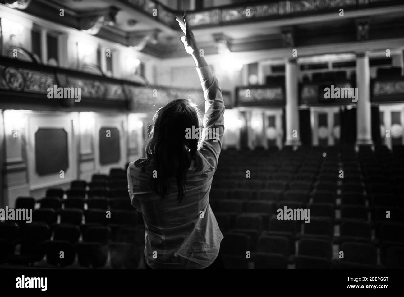 Entertainer performing on a stage in a empty theater,concert hall ...