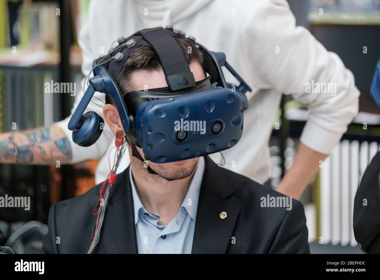 VR conference visitor tests virtual reality helmet Stock Photo - Alamy