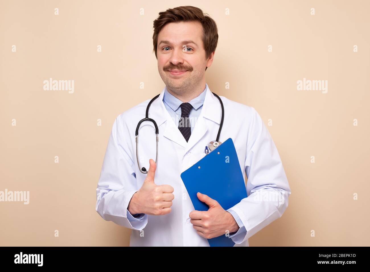 Successful doctor man giving thumbs up approving your choice or you ...