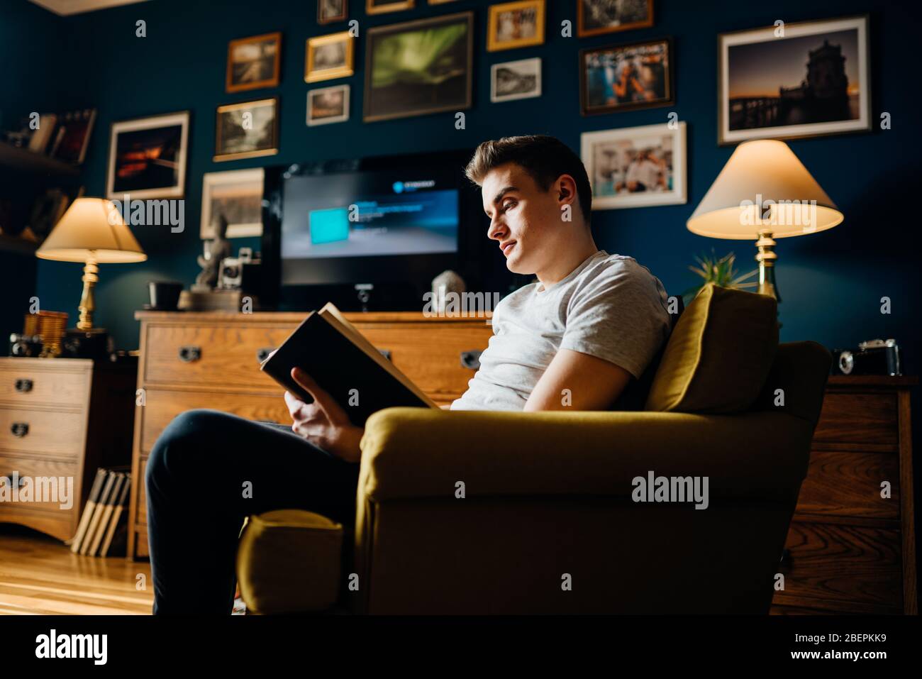 Man enjoying reading an interesting book,home alone in quarantine ...