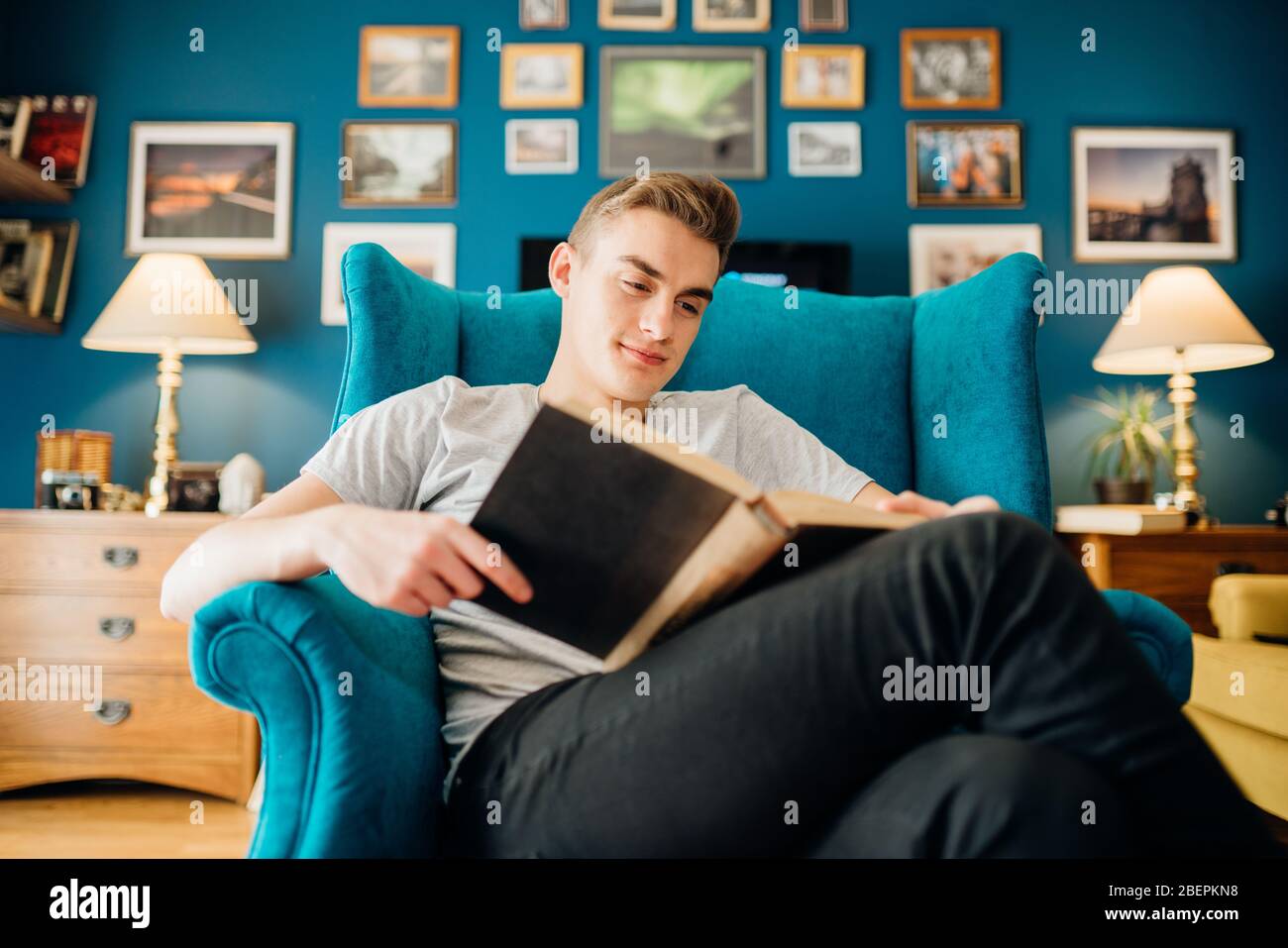 Man enjoying reading an interesting book,home alone in quarantine ...