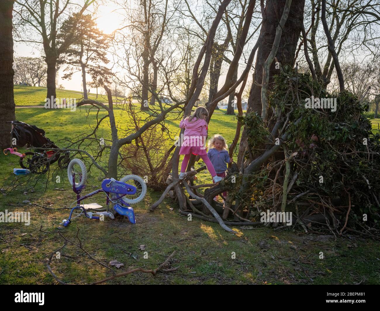 Two girls playing by a tree hi-res stock photography and images - Alamy