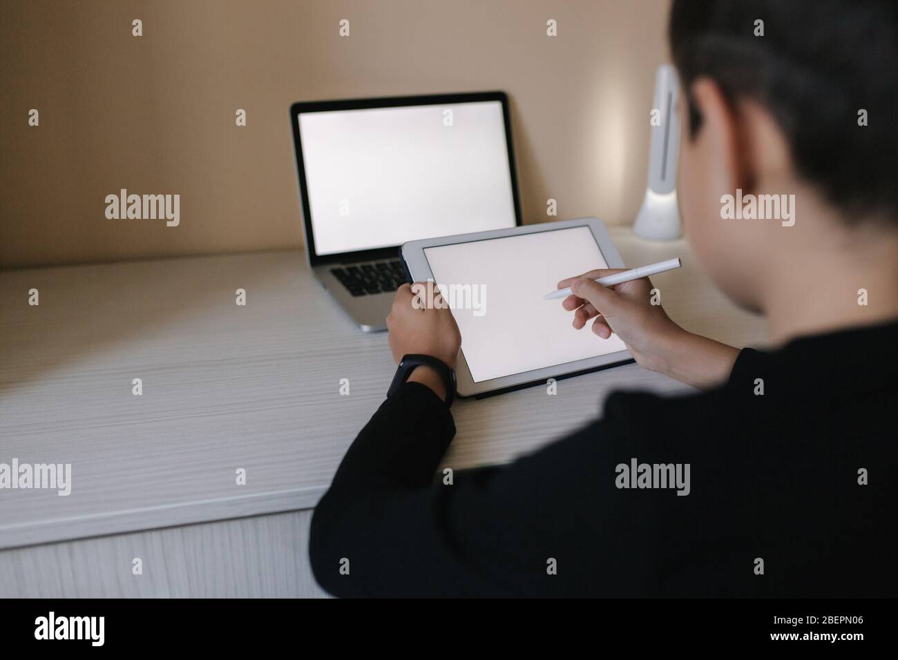 Handsome young boy drawing on tablet at home. Teenage boy use tablet ...