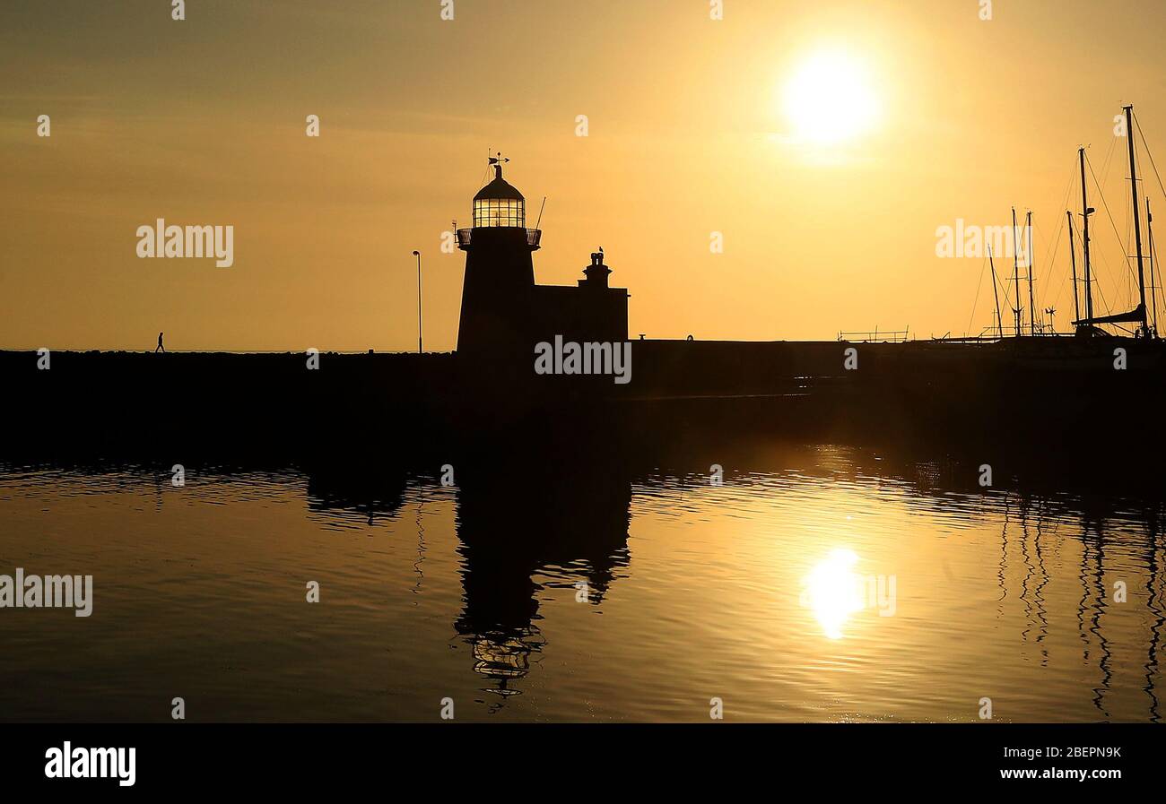 Sun rises above howth lighthouse hi-res stock photography and images ...