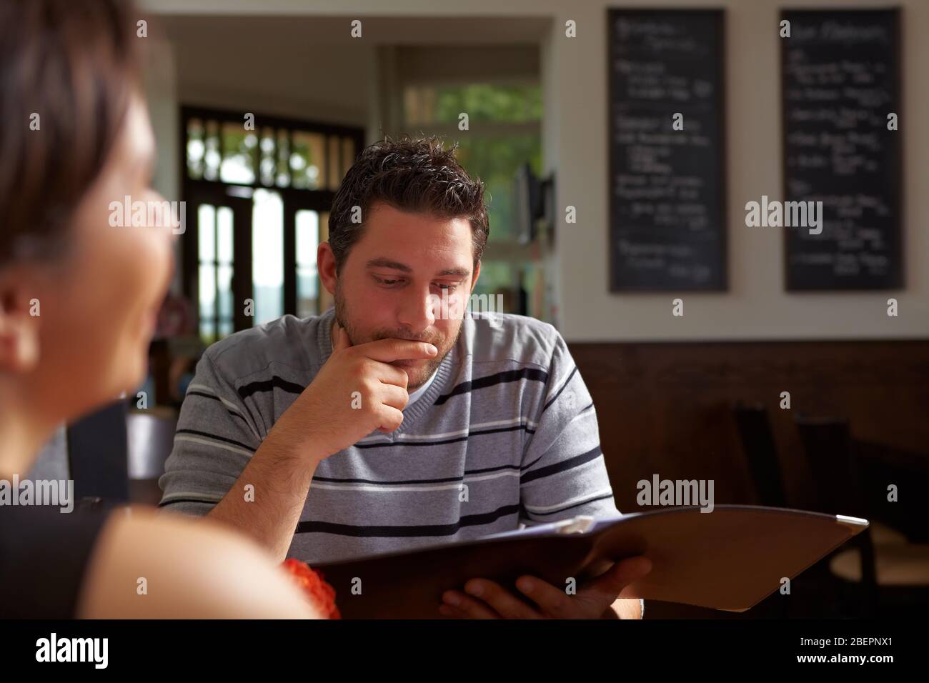 Couple viewing menu hi-res stock photography and images - Alamy