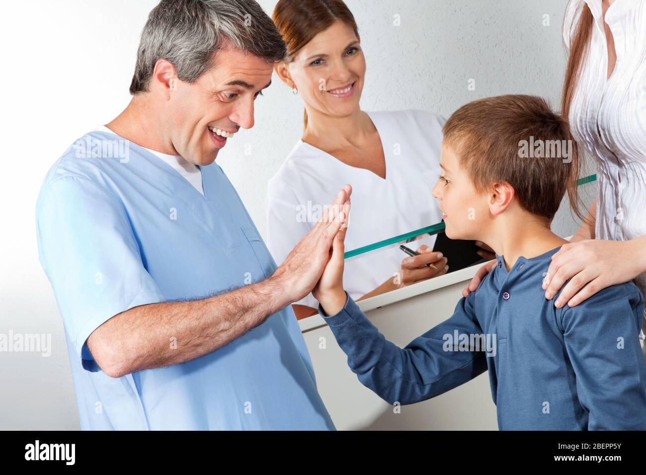 Doctor greets child with a high five handshake Stock Photo - Alamy