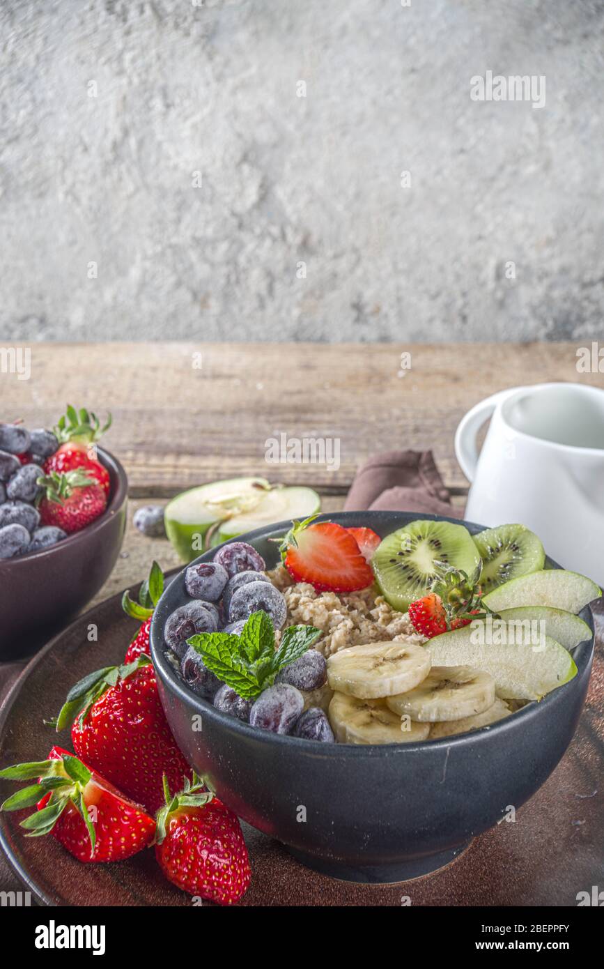 Breakfast oats. Morning oatmeal with various fruit and berries, on ...