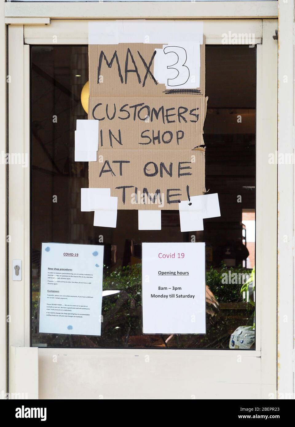 Notices on a butcher's shop door instructing and informing customers ...