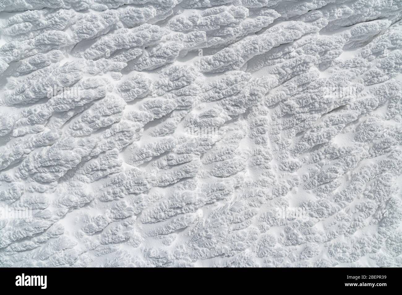 Icy texture of snow after a blizzard on a windy morning Stock Photo - Alamy