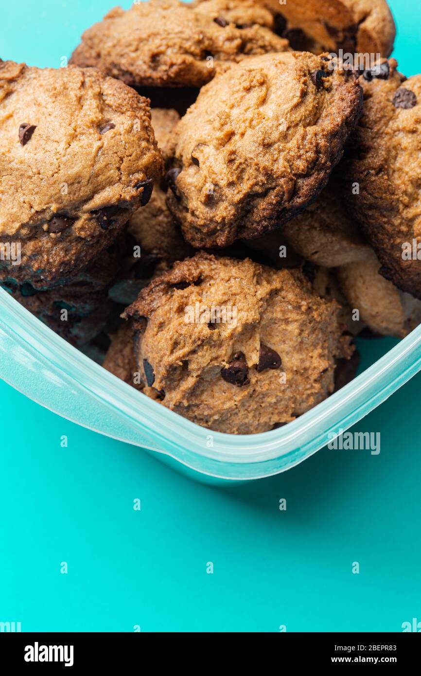 Chocolate cookies handmade on a plastic pot isolated on a green ...