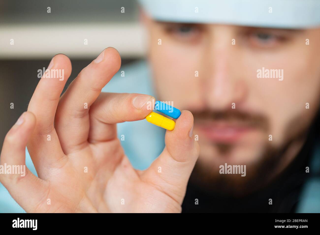 Close-up of male doctor holding pill for men health Stock Photo - Alamy