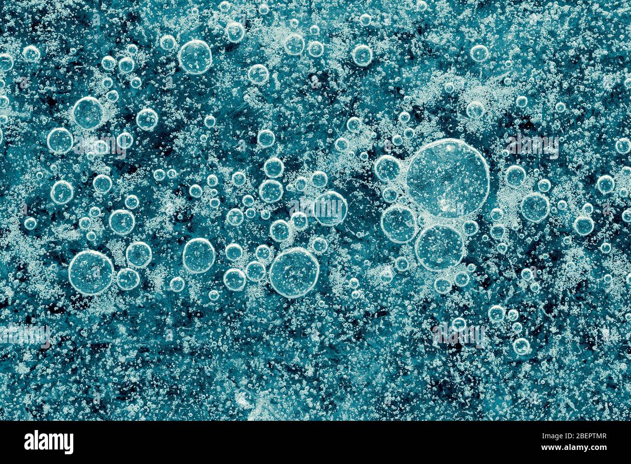 Bubbles trapped in ice blue Stock Photo - Alamy