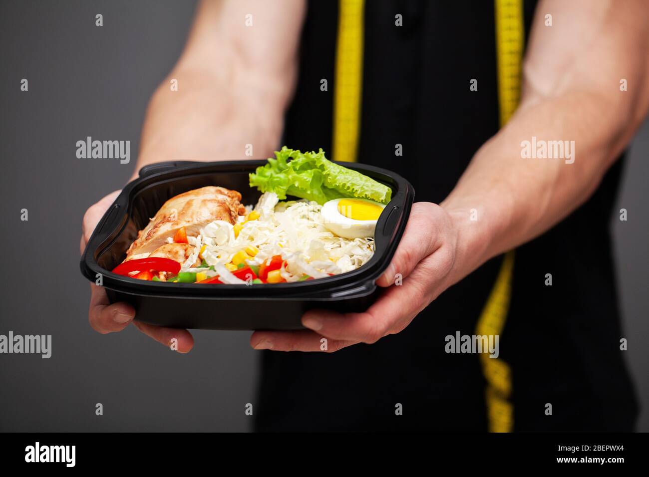 Closeup of a man holding a box full of protein rich foods for sports ...