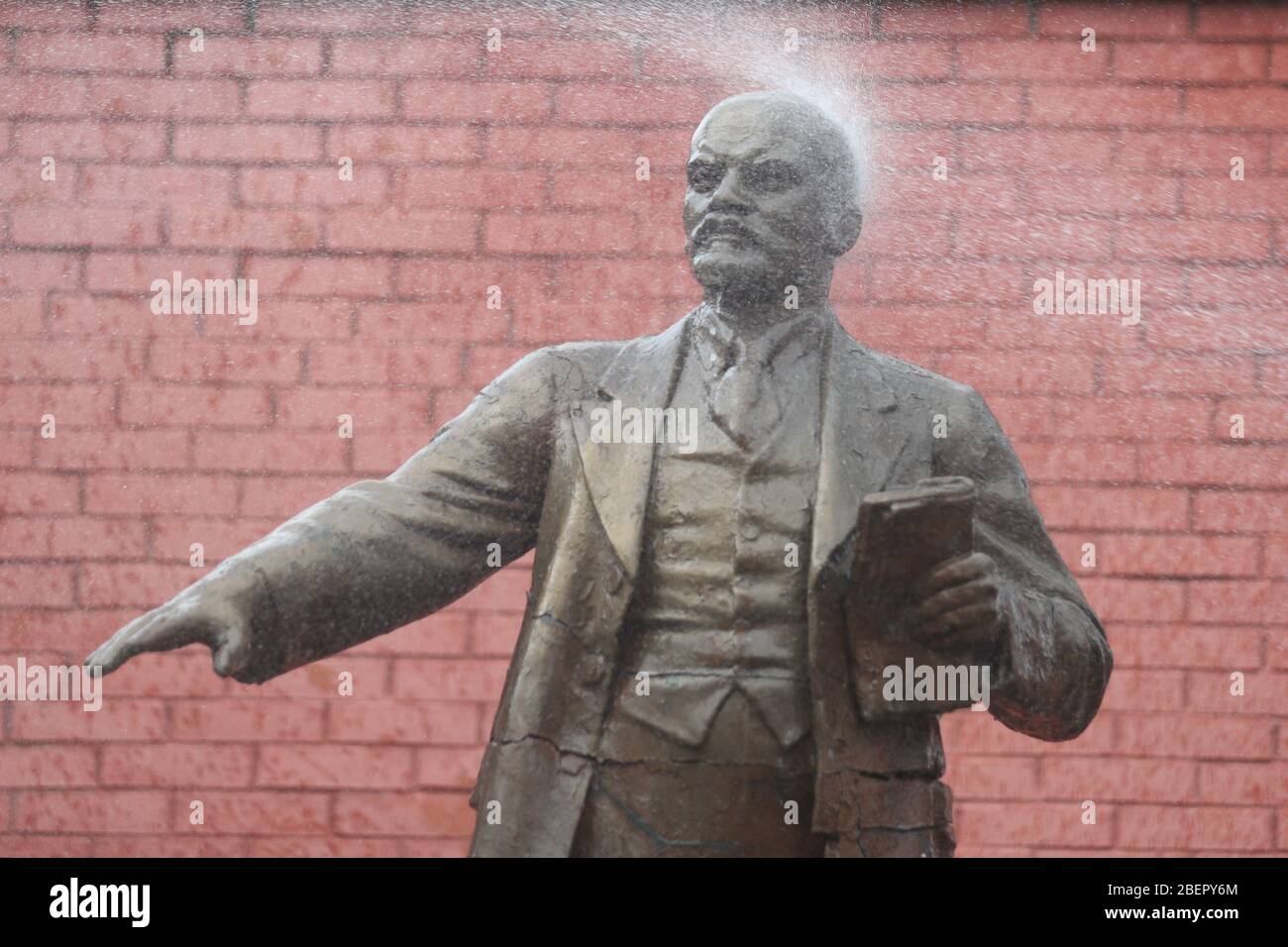 The monument of Vladimir Lenin being disinfected by Russian soldier at ...