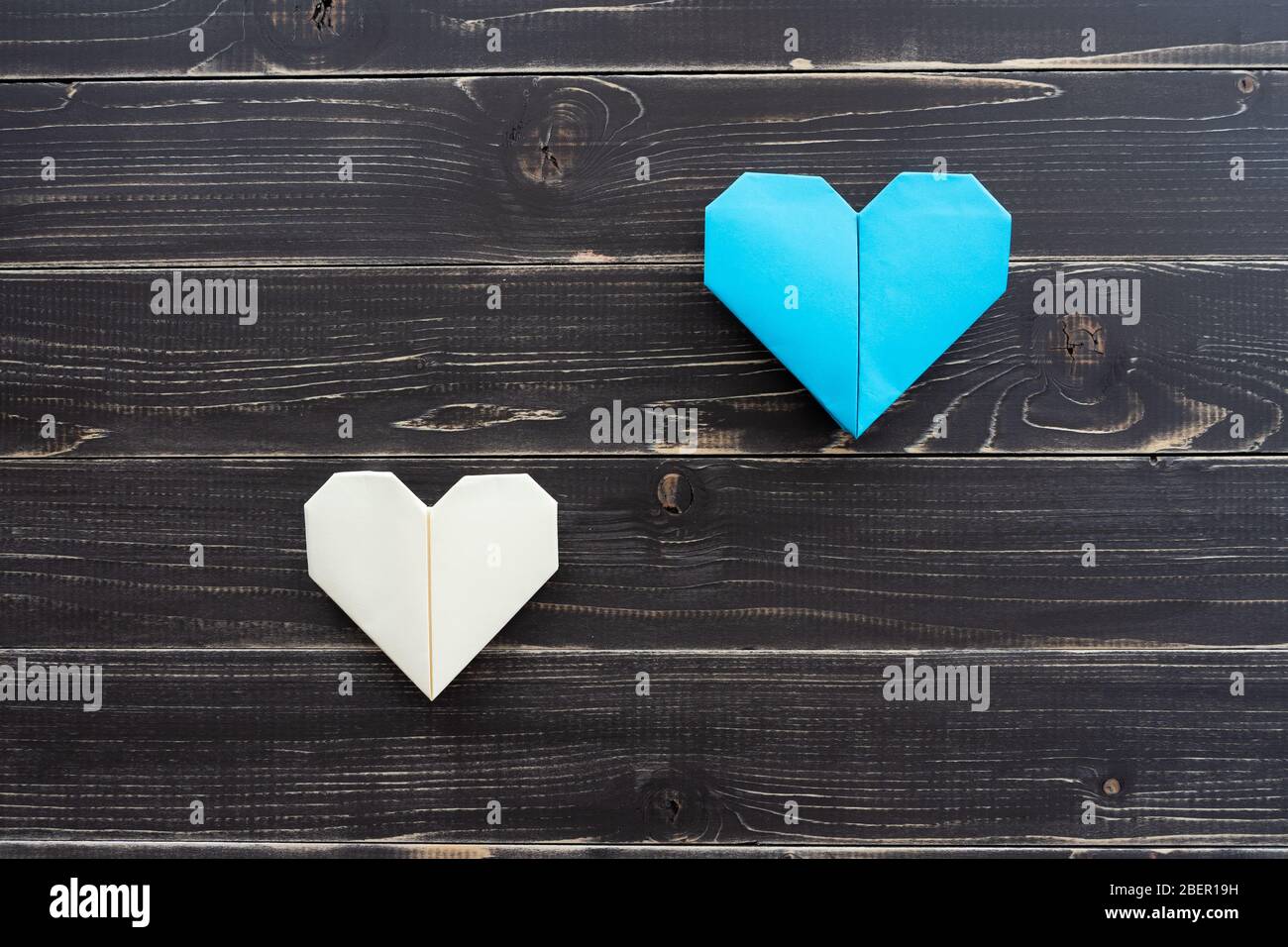 Origami hearts of different colors and sizes in composition on ...