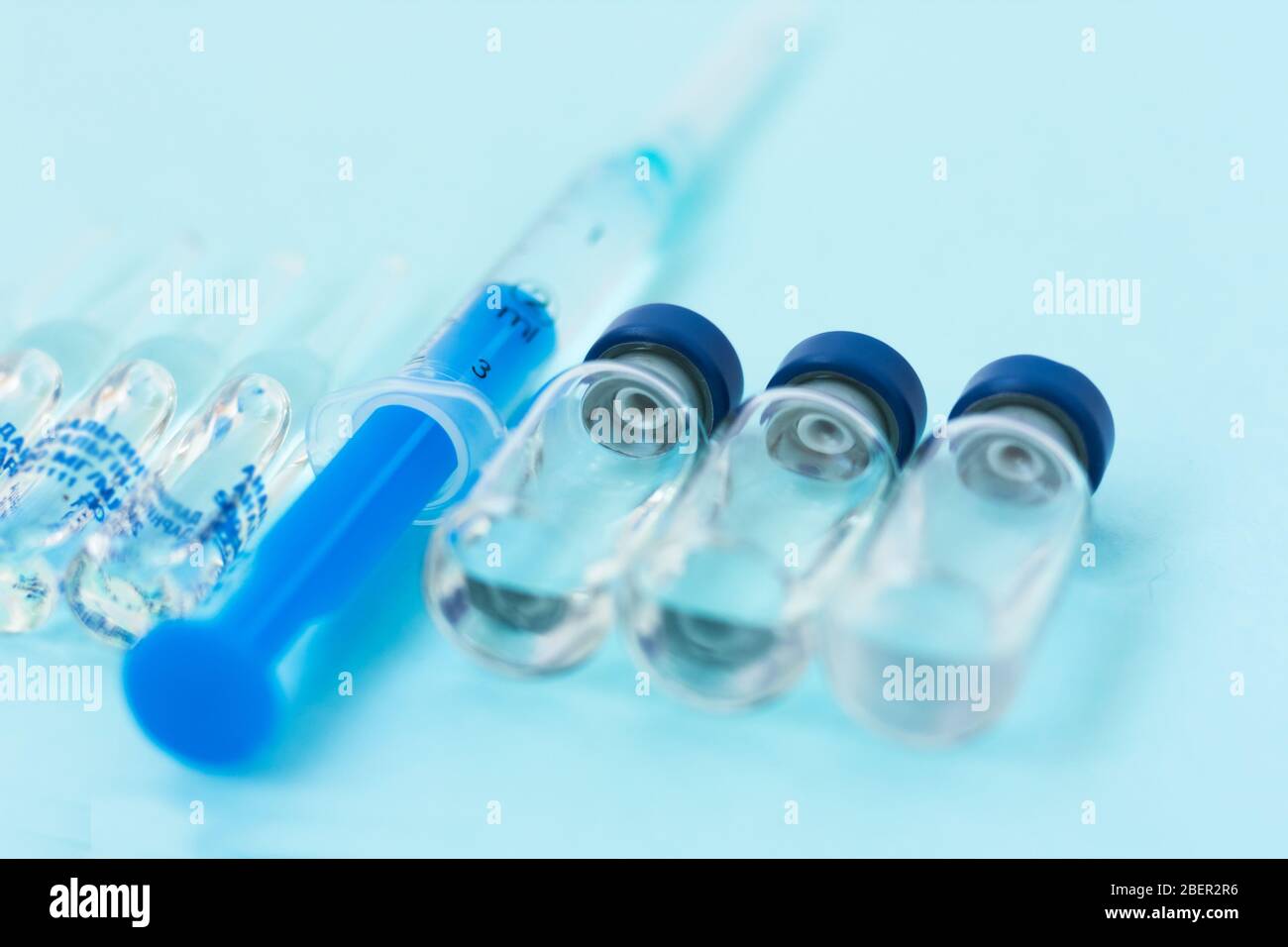 injection ampoules, syringe for vaccination on a blue background ...