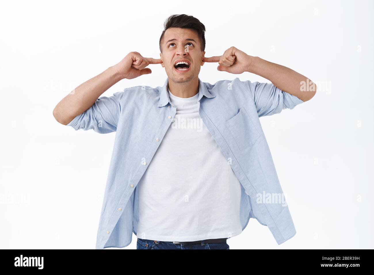 Portrait of bothered and annoyed handsome man hate his neighbours, shut ...