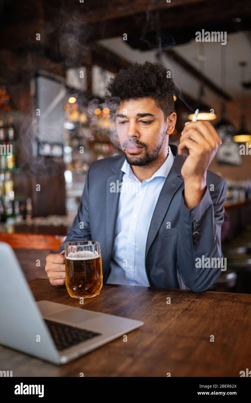 Man drinking beer smoking cigarette hi-res stock photography and images ...