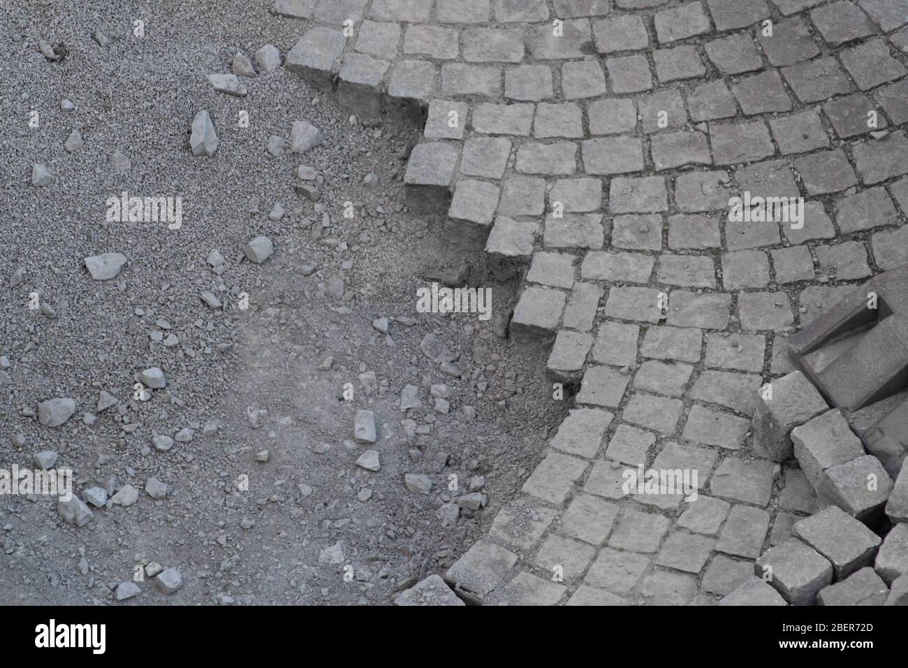 Top view on a construction site with missing paving stones and some ...