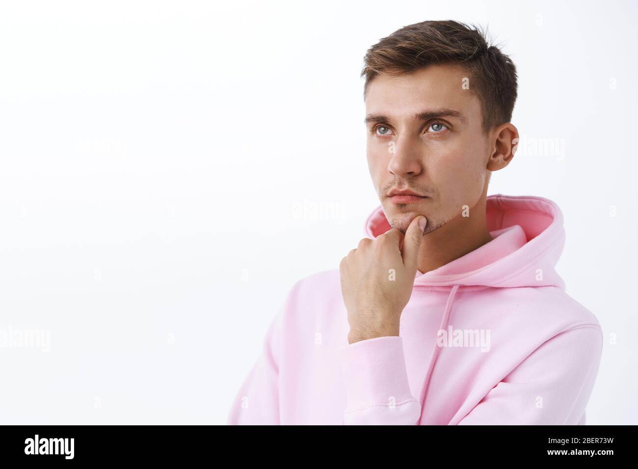 Portrait of serious-looking blond young man with judgemental skeptical ...