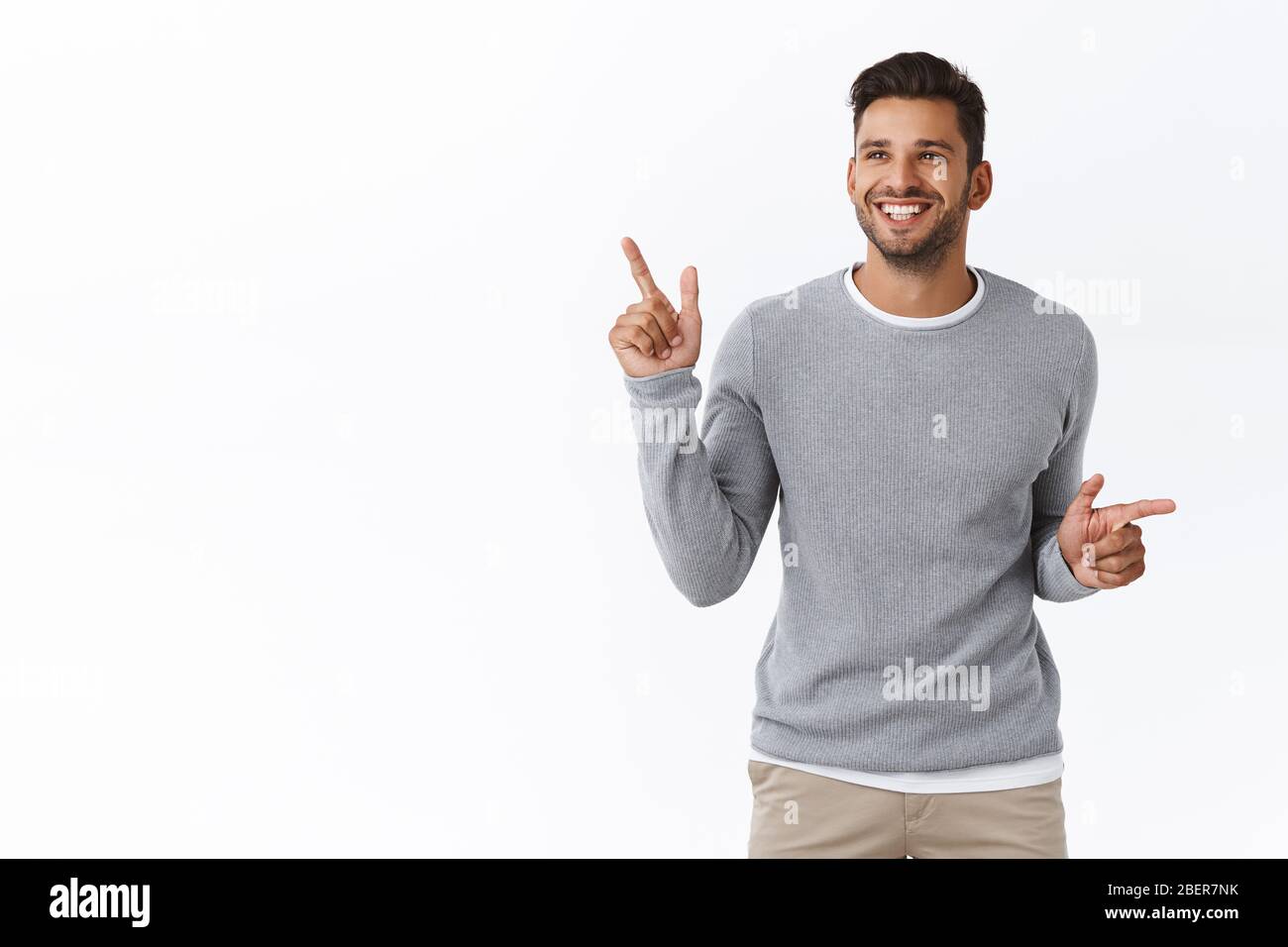 Satisfied young handsome man with bristle wander around shopping mall ...