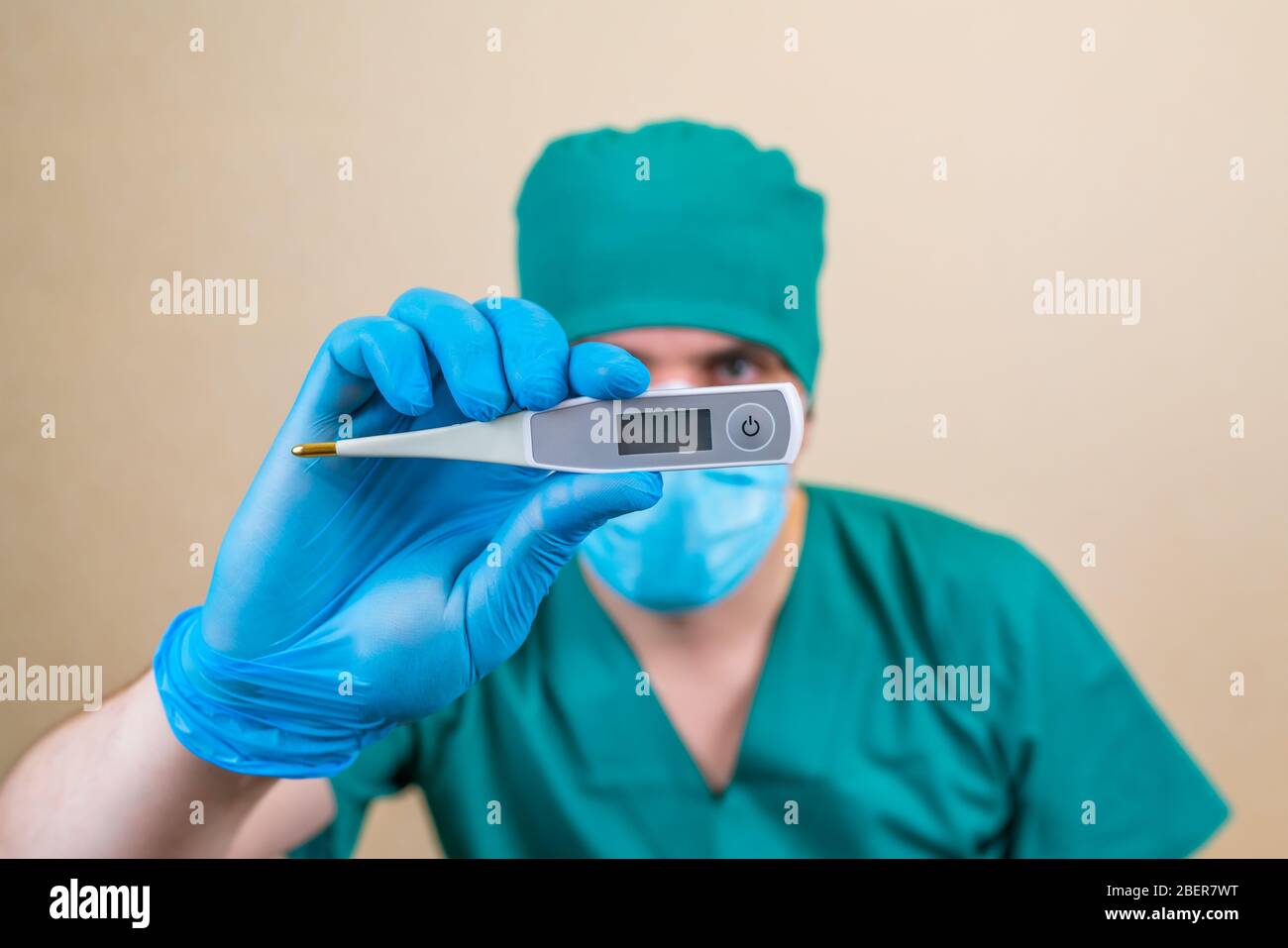 Thermometer in doctors hand on yellow background. Copy space ...