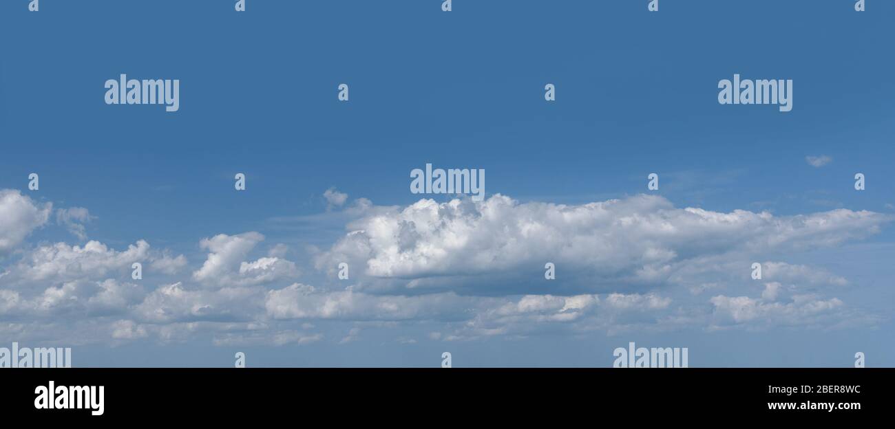 Wide blue sky background with cumulus clouds and copy space Stock Photo ...