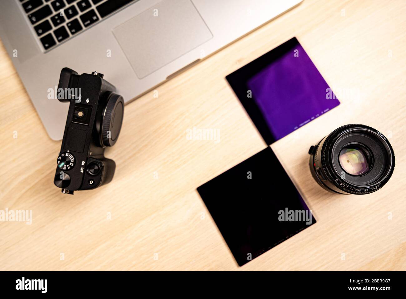 Laptop, lens and headphones with camera Stock Photo - Alamy