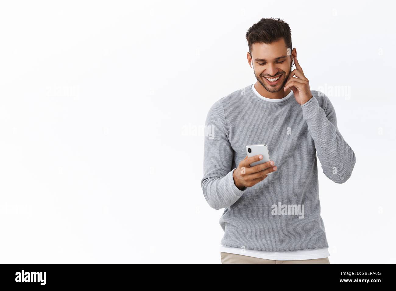 Cheerful young man listen voice message in smartphone app using ...