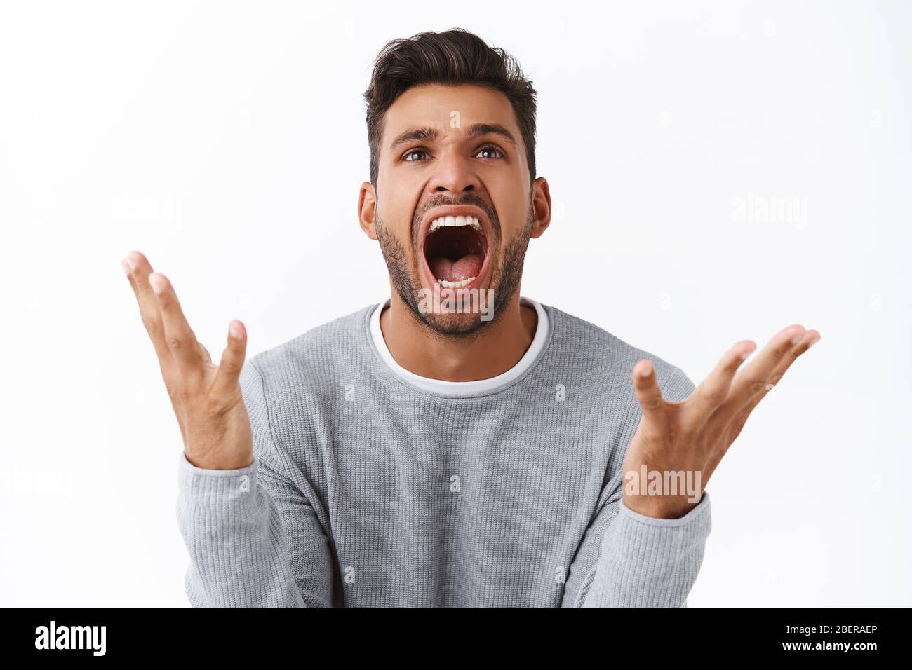 Bothered and pressured, intense angry guy scream from anger and ...