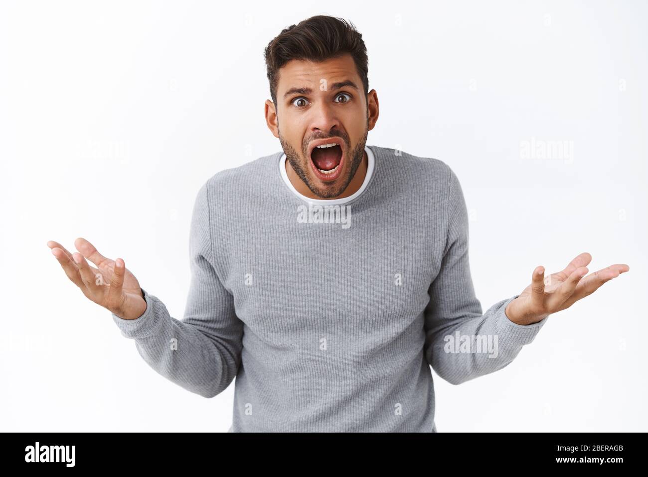Pressured handsome guy having intense argument, screaming with ...
