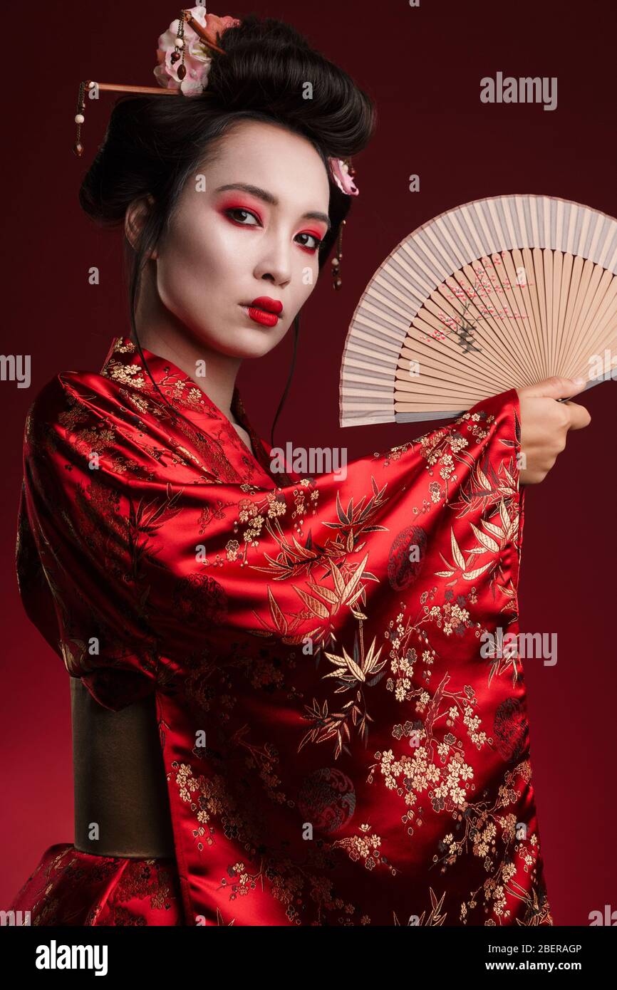 Image of young geisha woman in traditional japanese kimono holding ...