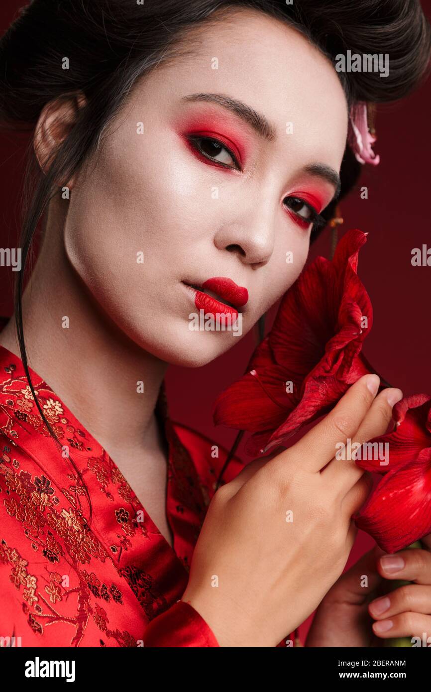 Image of beautiful geisha woman in traditional japanese kimono holding ...