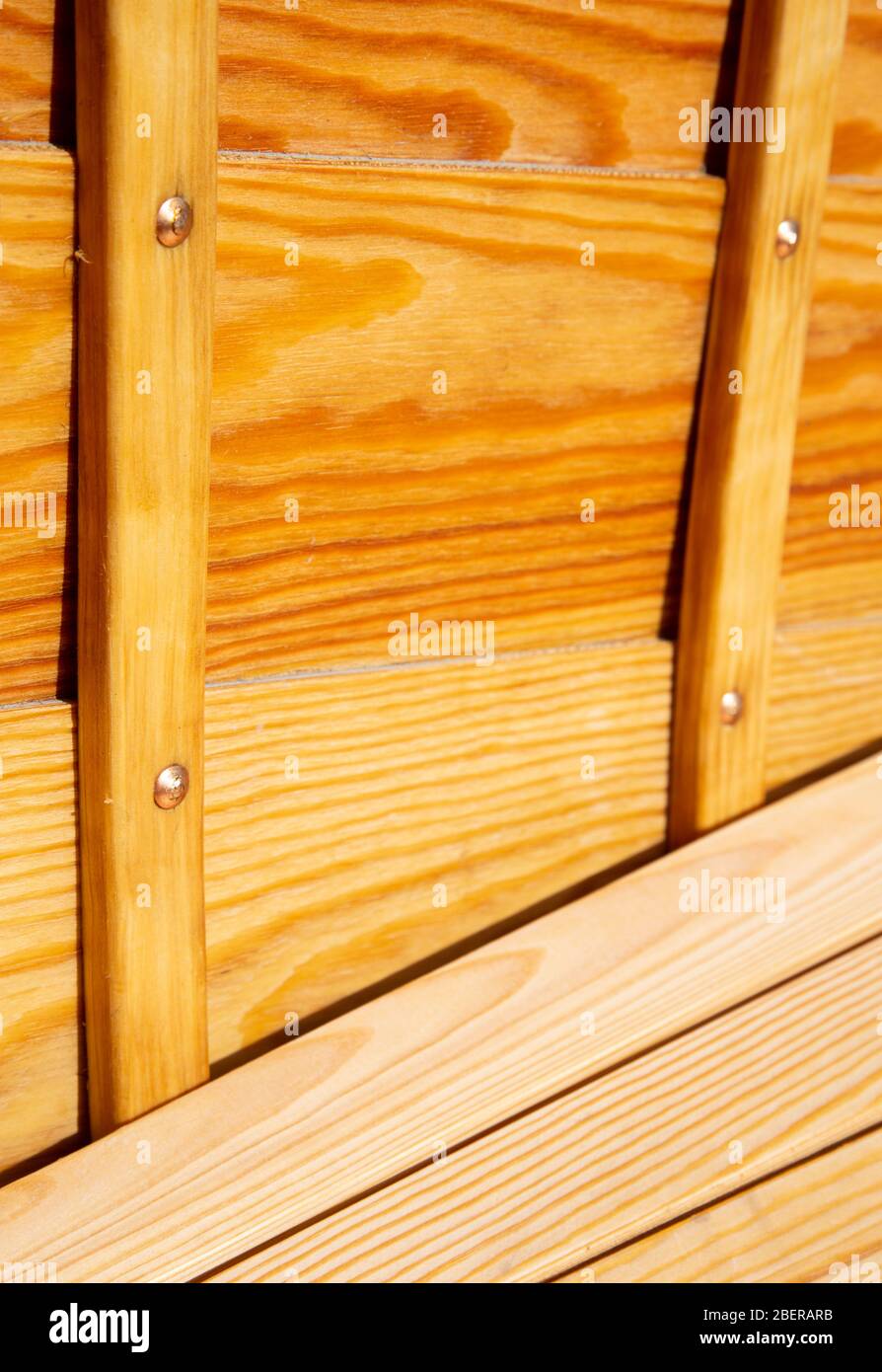 Closeup of a wooden boat ribs with copper nail ends, which holds the ...