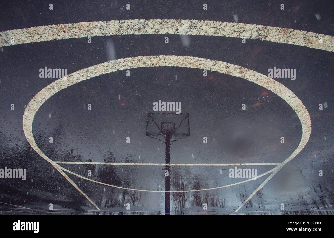 Basketball court after rain. Basketball half-court line. Outdoor court ...