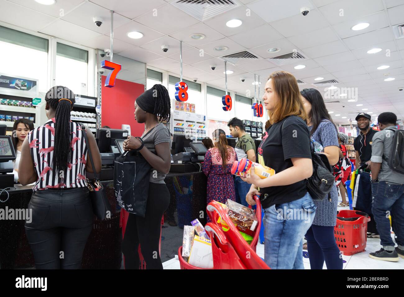 Buyers stand in line at the checkout in supermarket Stock Photo - Alamy