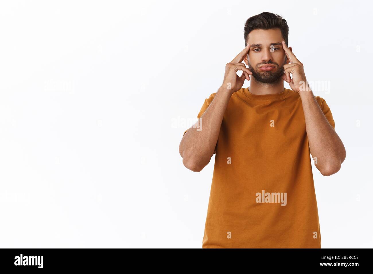 Tired and upset bored young handsome hipster guy, massging temples with ...