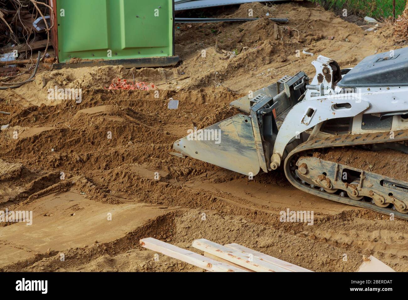 Bulldozer moving, leveling ground at construction site in ground using ...