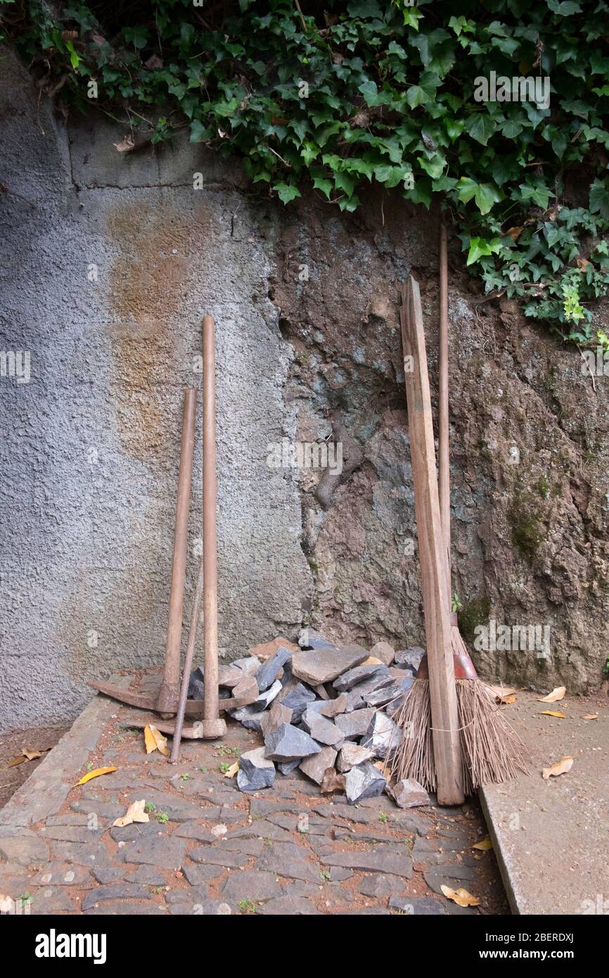 Rough cut stones and tools used to repair a walkway Stock Photo - Alamy