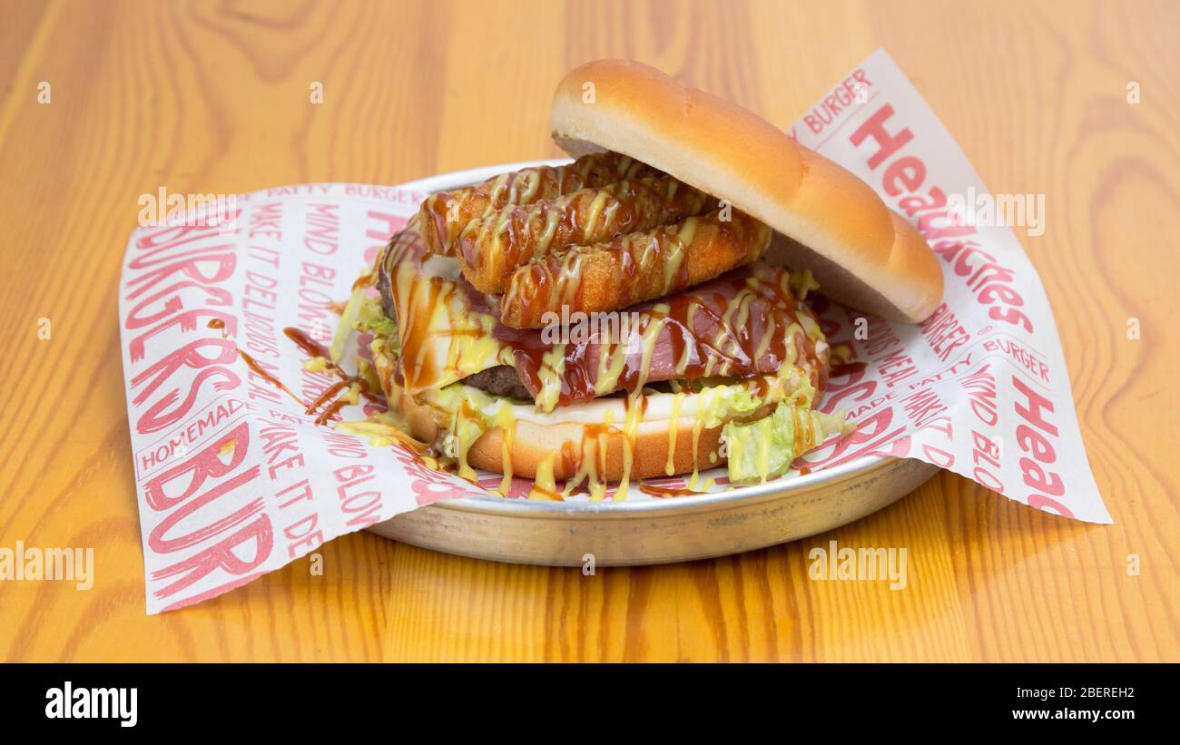 Opened cheeseburger with breaded sausages and mustard. Hamburger with ...