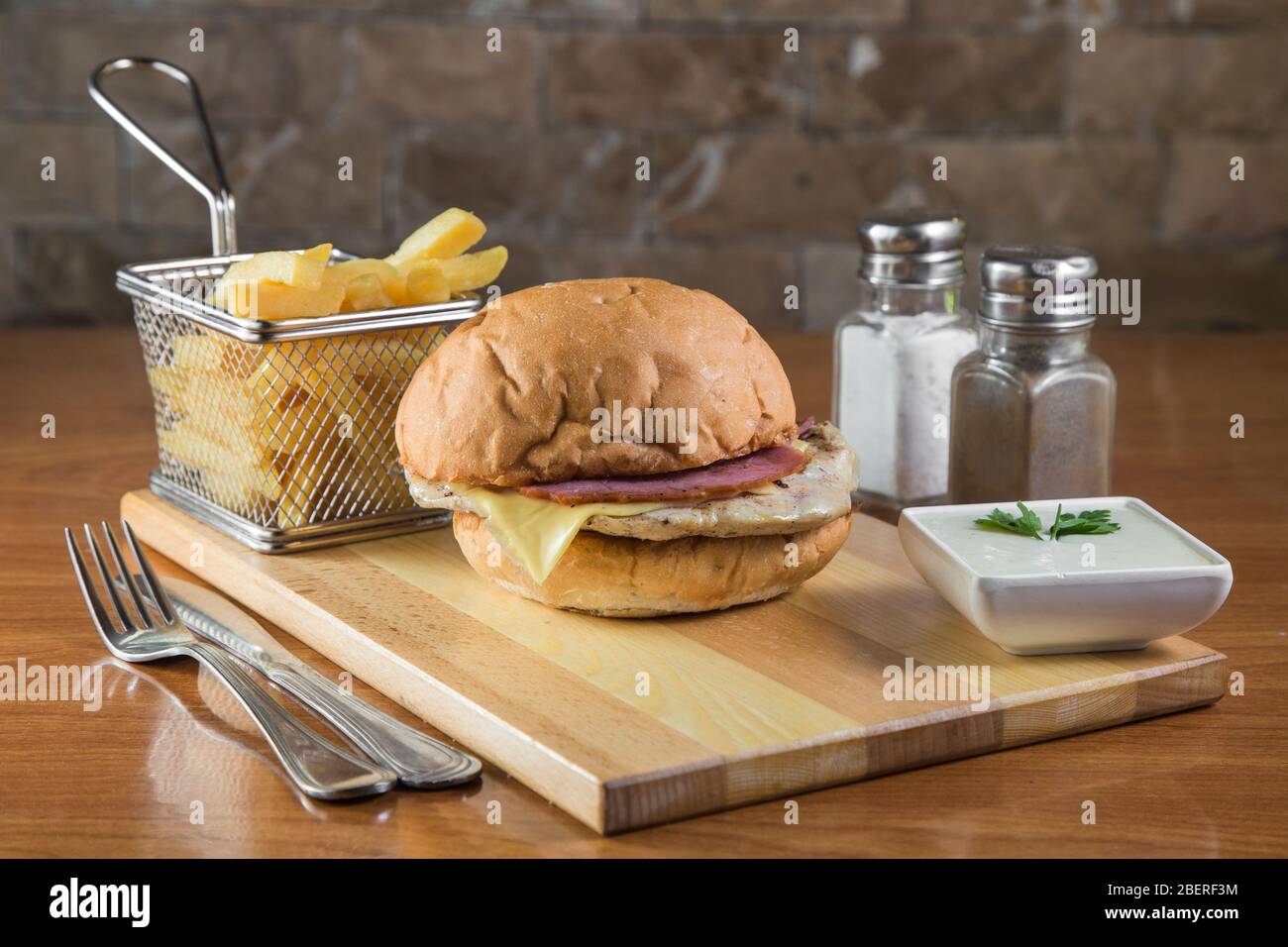 Steak in between two buns with salami and yellow cheese. Hamburger with ...