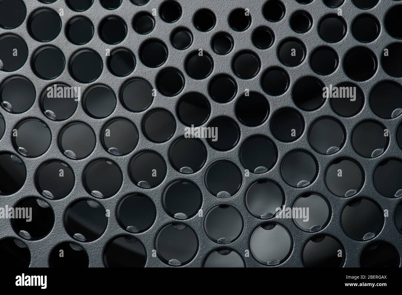 Perforated black matte surface macro close up view Stock Photo - Alamy